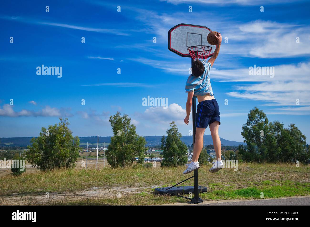 One handed practice slam dunk at home by young man Stock Photo - Alamy