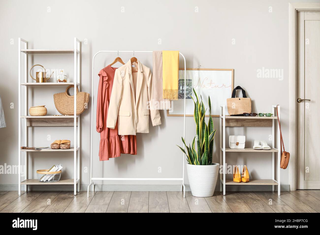 Stylish female clothes and shelf unit in room Stock Photo - Alamy