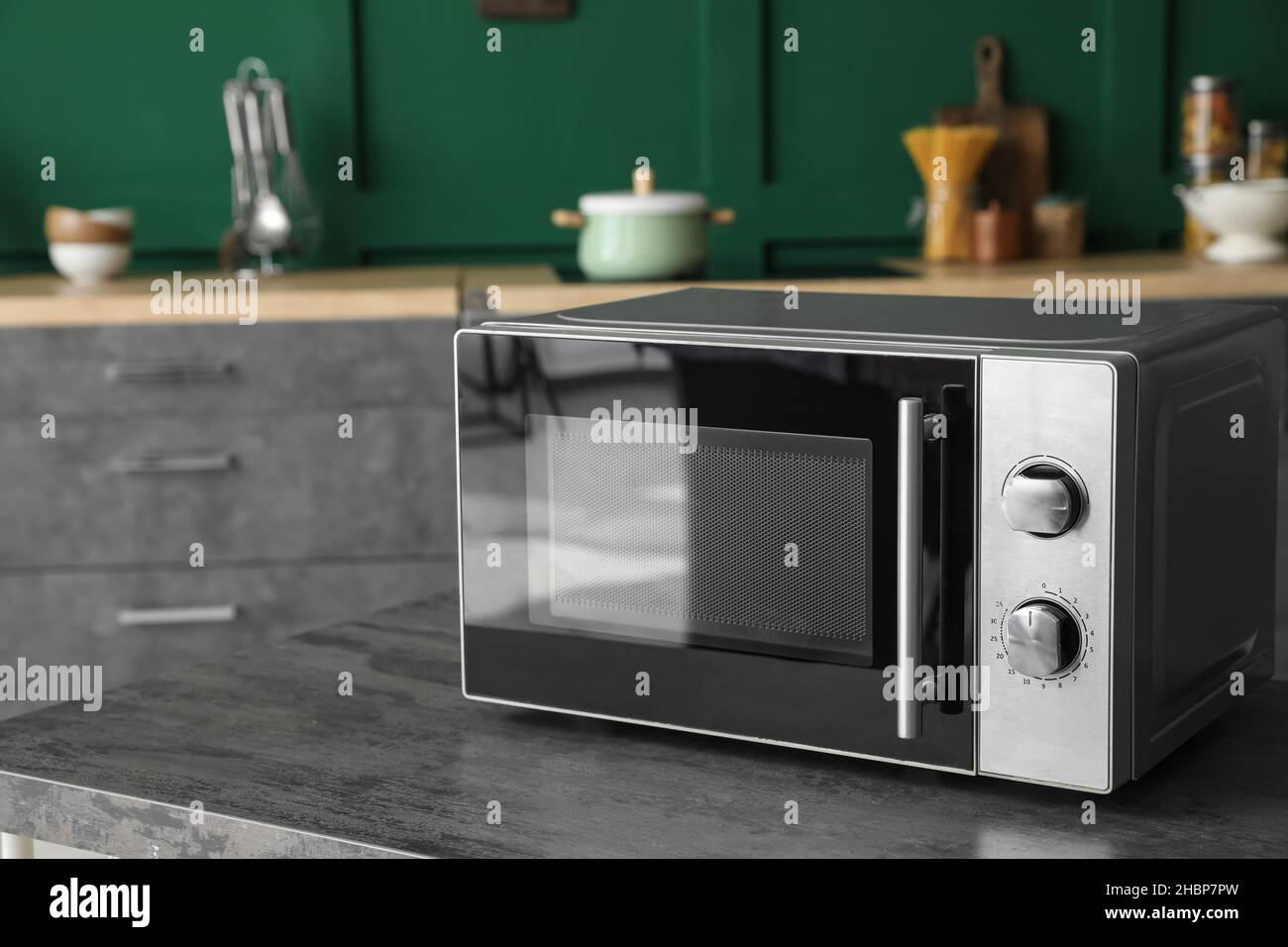 Modern microwave oven on table in kitchen Stock Photo - Alamy