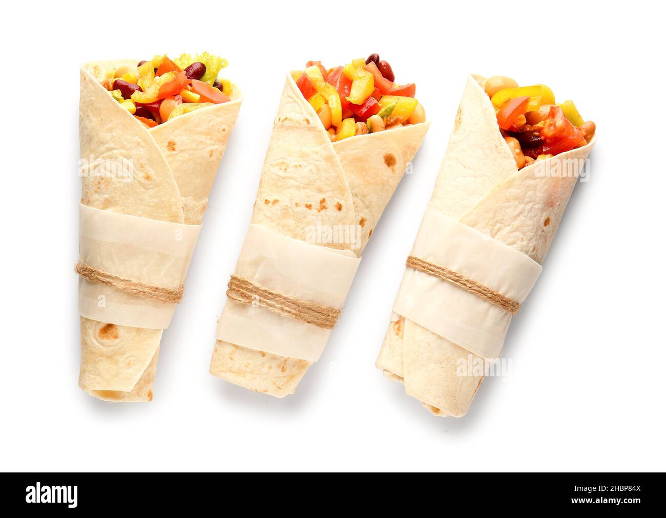 Tasty Mexican burritos with vegetables on white background Stock Photo ...