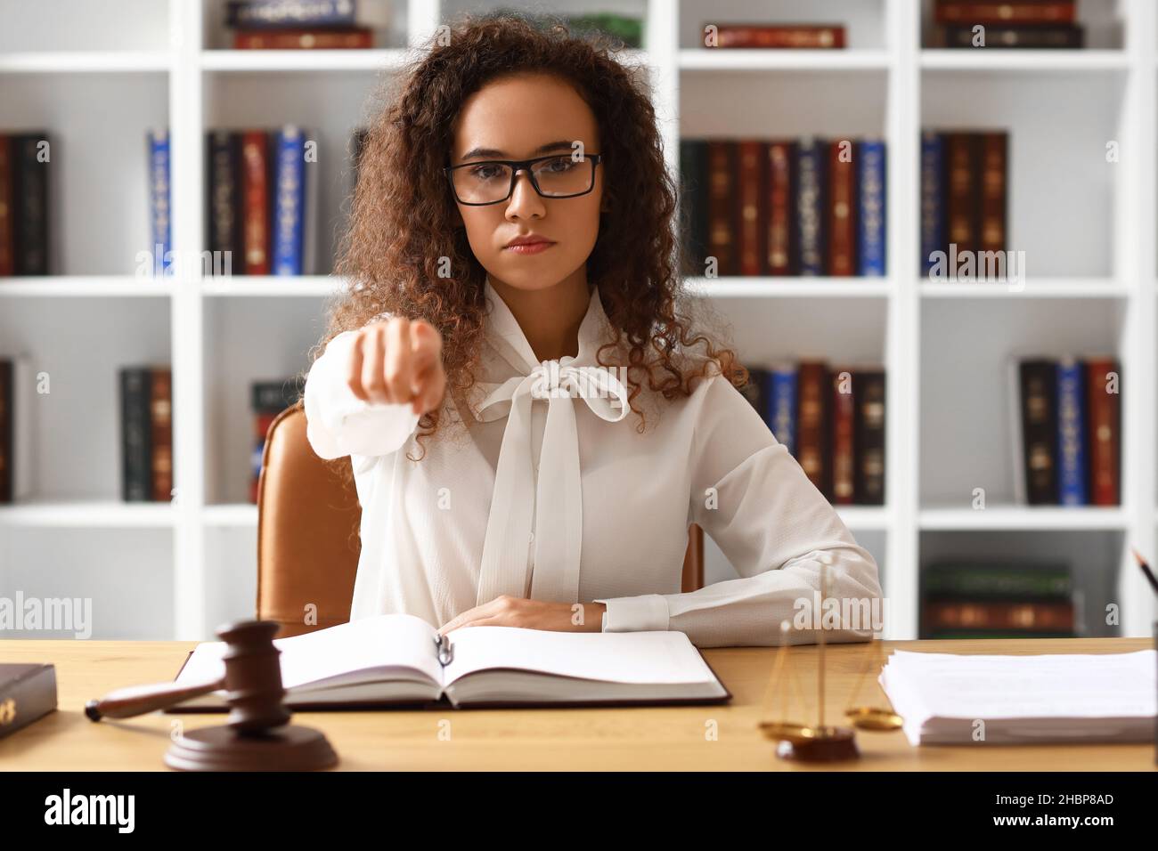 Young female judge pointing at viewer in courtroom Stock Photo - Alamy