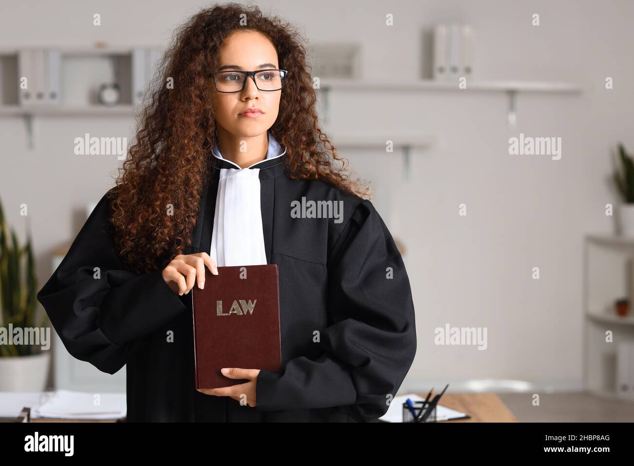 Portrait of female judge with law book in courtroom Stock Photo - Alamy