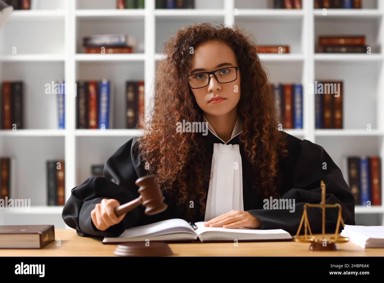 Female judge with gavel at workplace in courtroom Stock Photo - Alamy