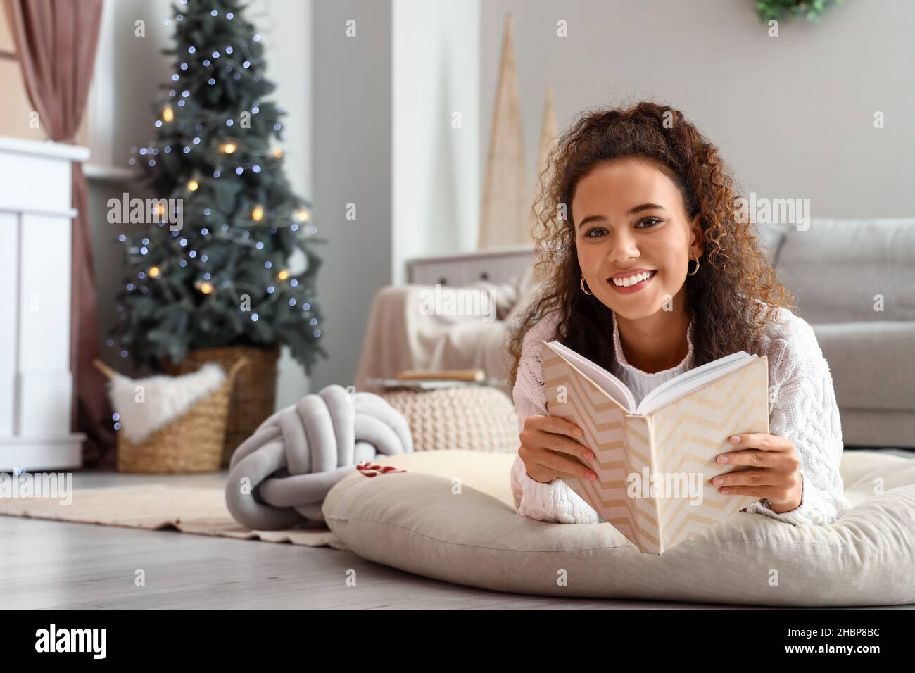 Pretty young woman reading interesting book at home Stock Photo - Alamy