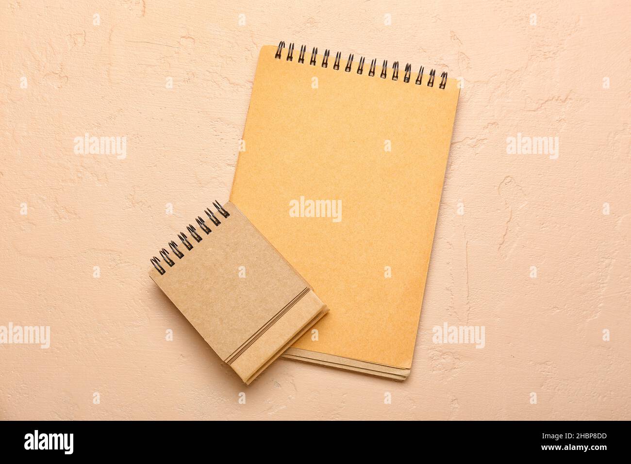 Blank craft calendar and notebook on color background Stock Photo - Alamy