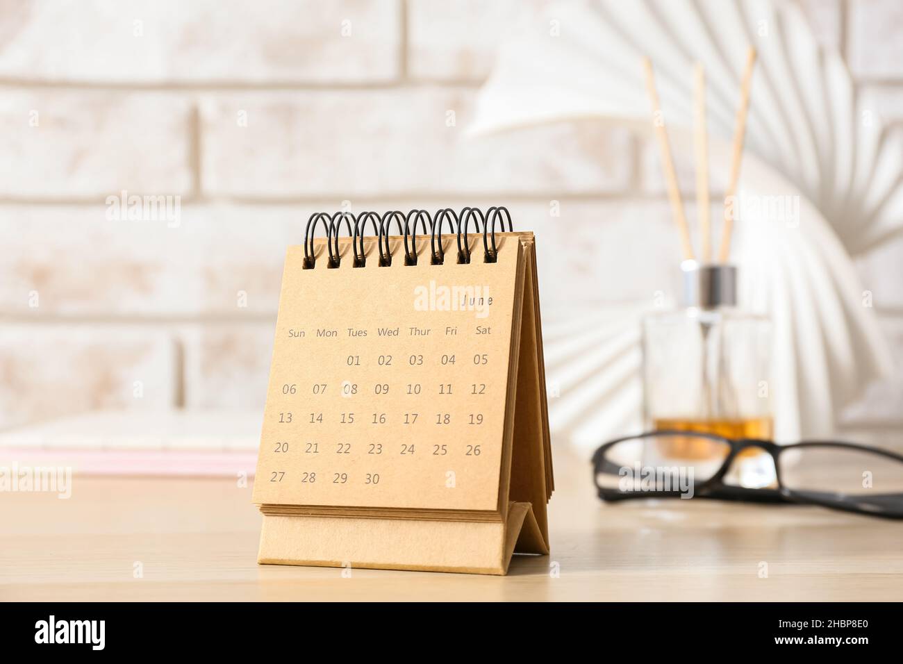 Craft calendar on table against light brick wall Stock Photo - Alamy