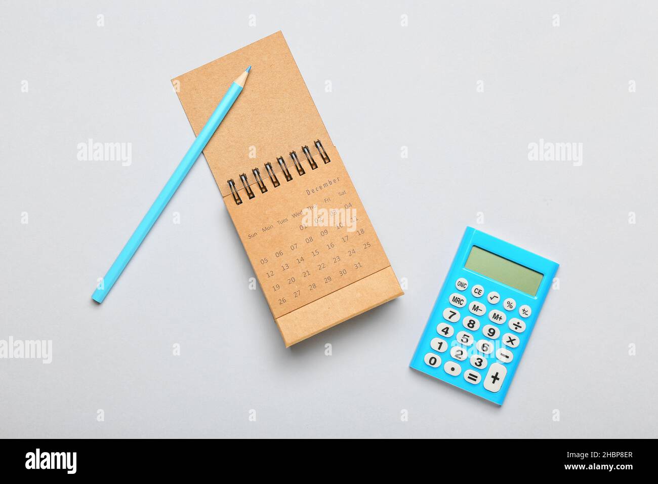 Craft calendar, pencil and calculator on grey background Stock Photo ...