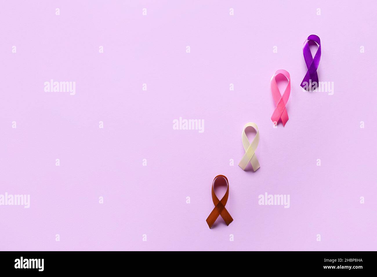 Different awareness ribbons on lilac background. World Cancer Day Stock ...