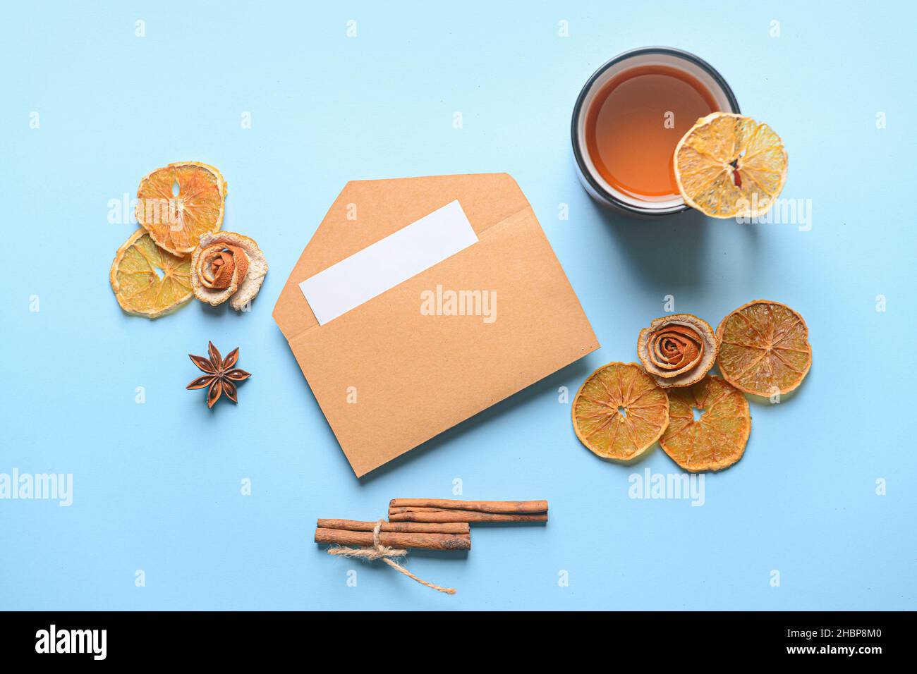Envelope with spices and cup of tea on color background Stock Photo - Alamy