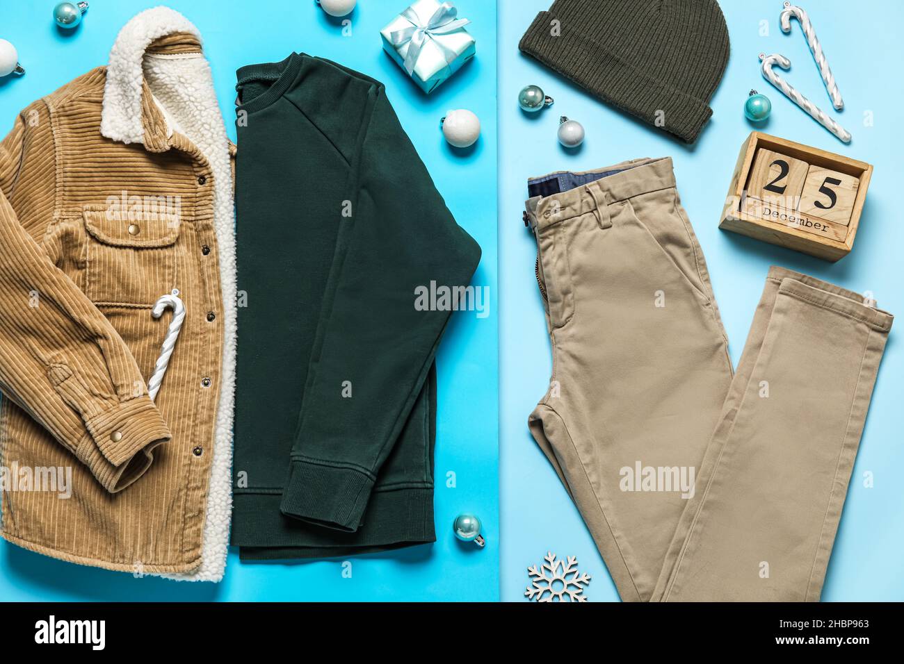 Set of children's clothes and calendar with date of Christmas on color ...