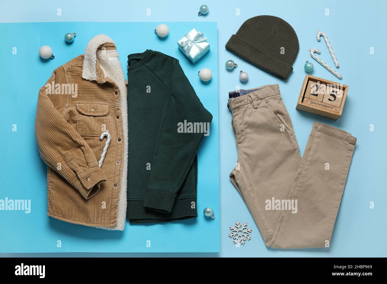 Set of children's clothes and calendar with date of Christmas on color ...