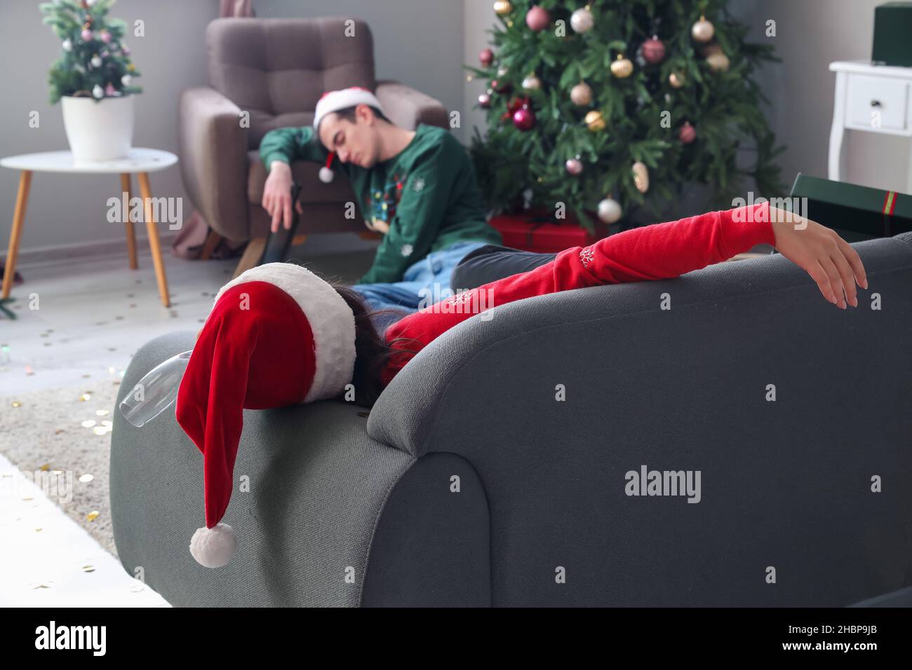 Drunk young people sleeping after Christmas party at home Stock Photo ...