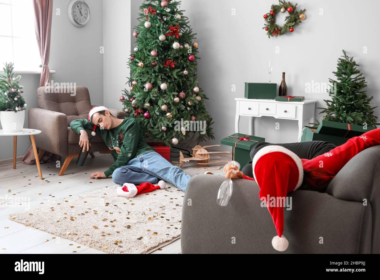 Drunk young people sleeping after Christmas party at home Stock Photo ...