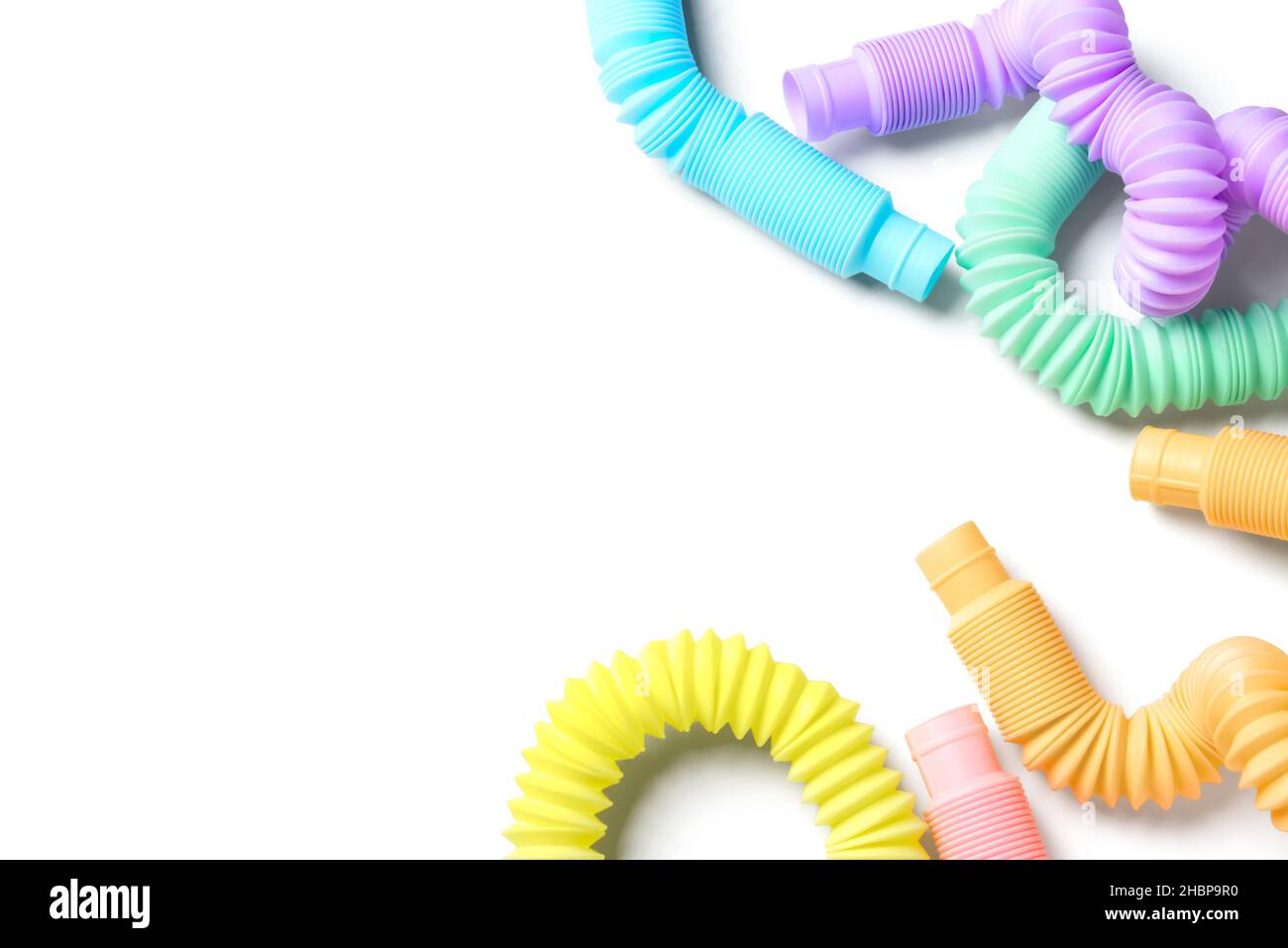 Different colorful Pop Tubes on white background Stock Photo - Alamy