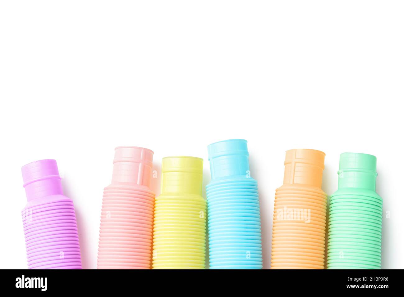 Different colorful Pop Tubes on white background Stock Photo - Alamy