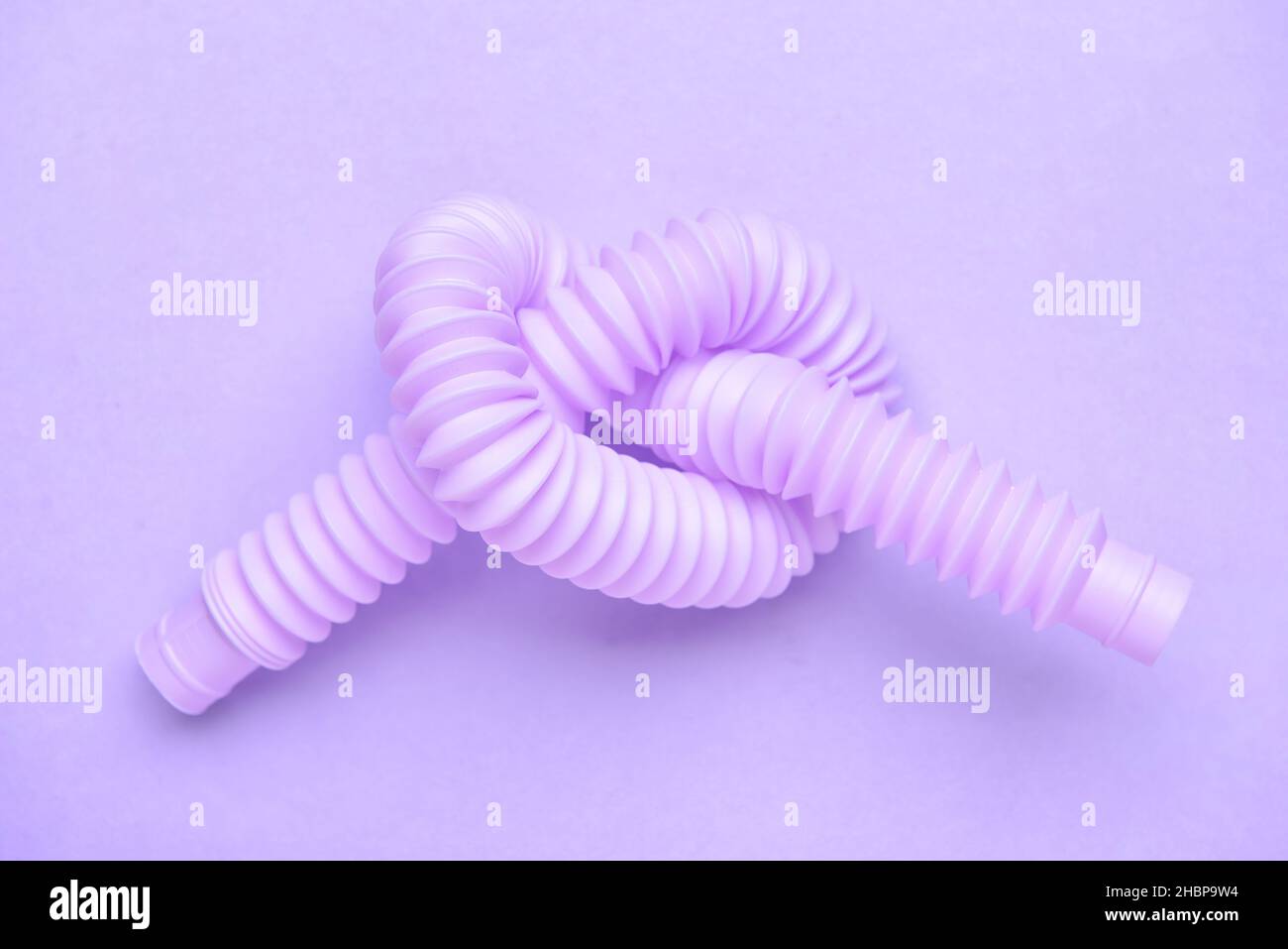 Pop Tube on purple background Stock Photo - Alamy