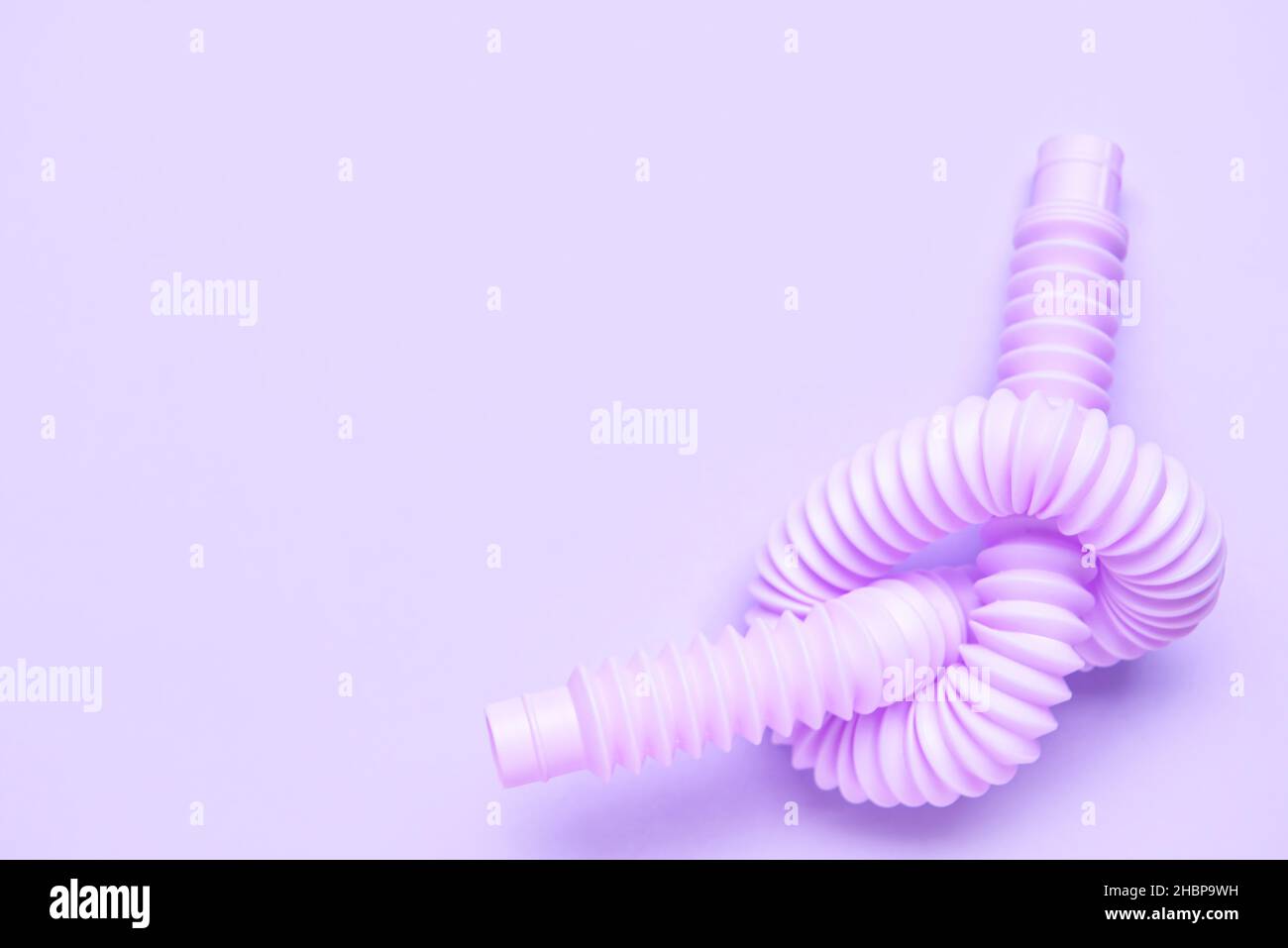 Pop Tube on purple background Stock Photo - Alamy