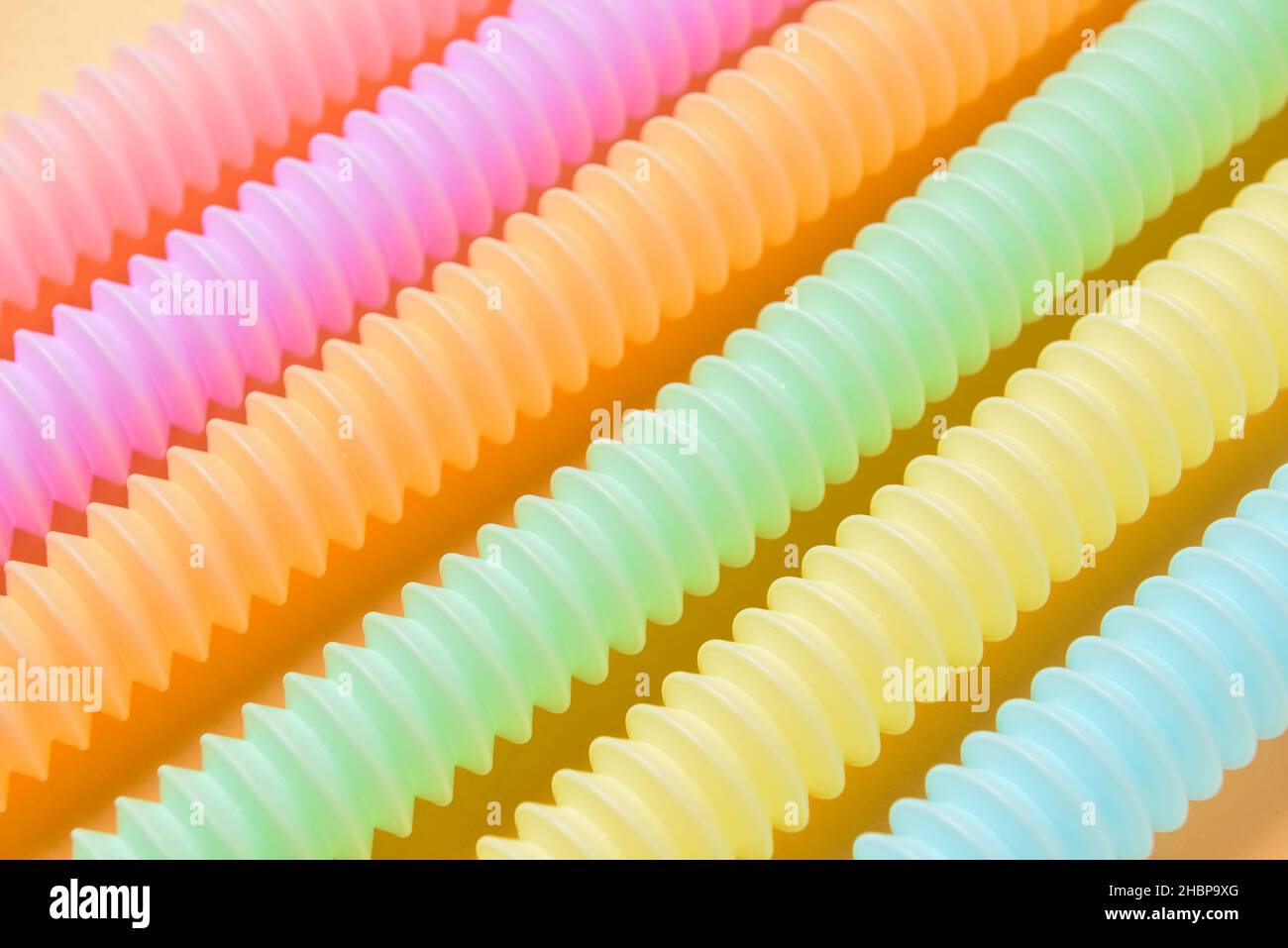 Different colorful Pop Tubes on color background, closeup Stock Photo ...