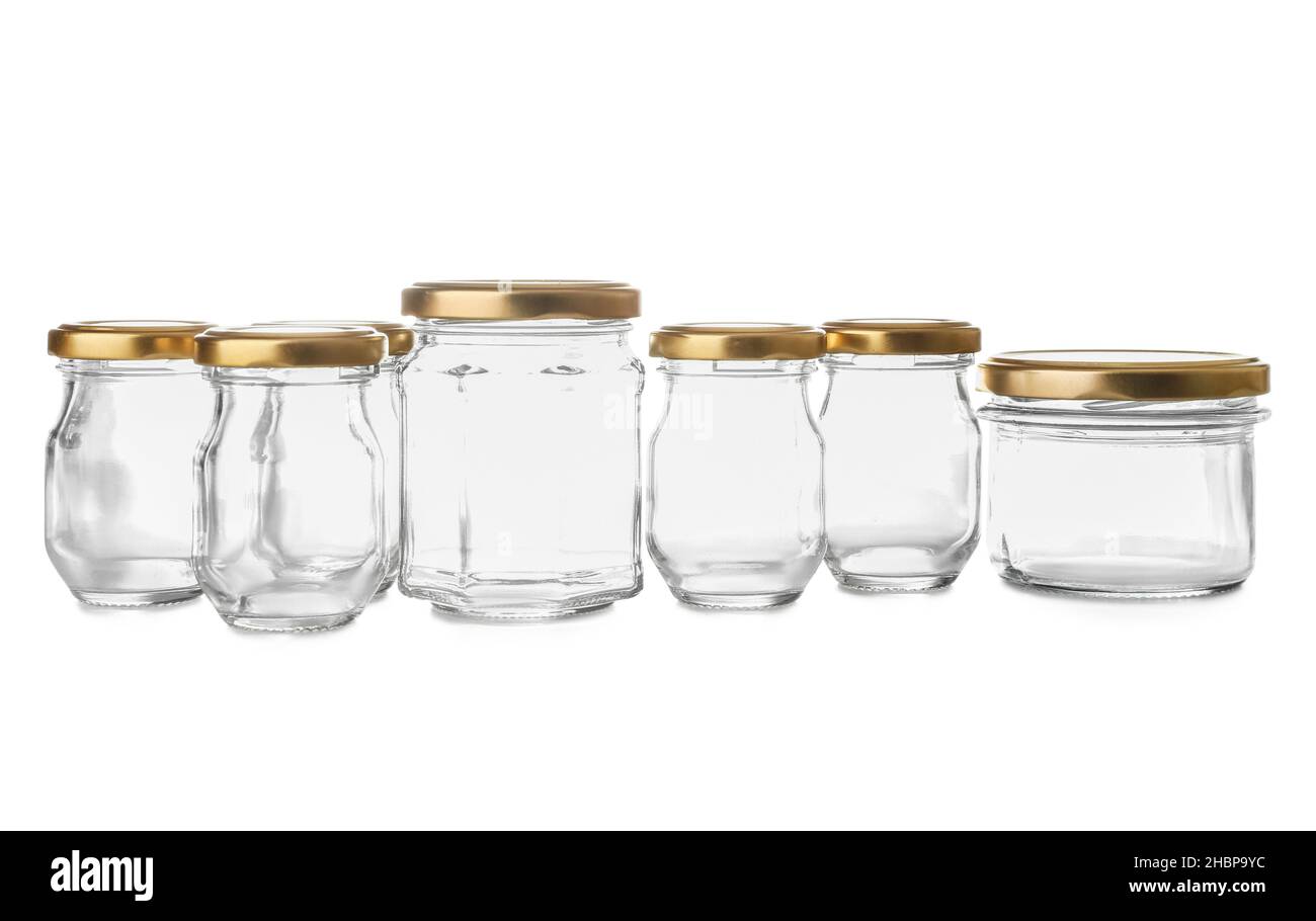 Different glass jars on white background Stock Photo - Alamy
