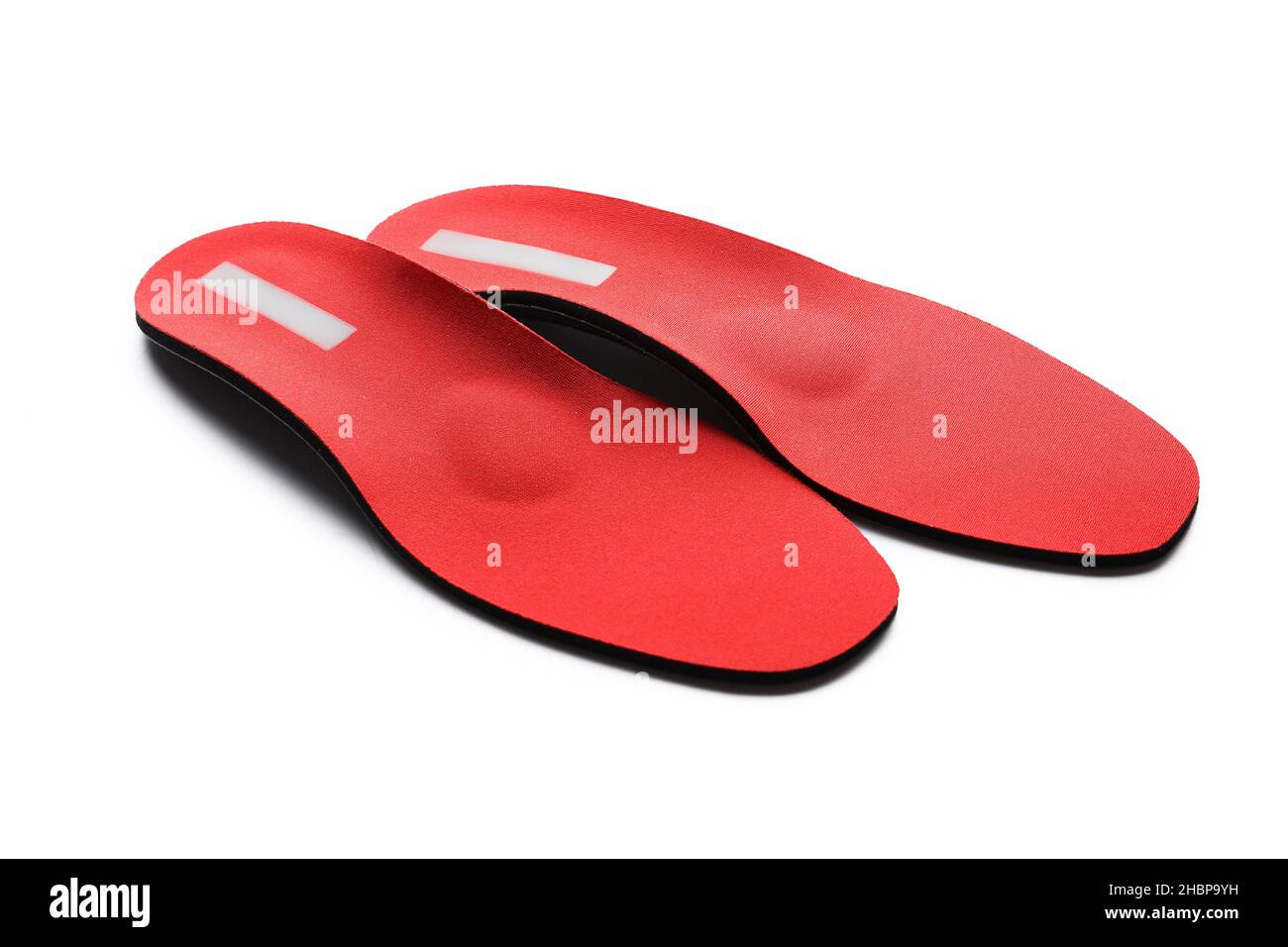 Red orthopedic insoles on white background Stock Photo - Alamy