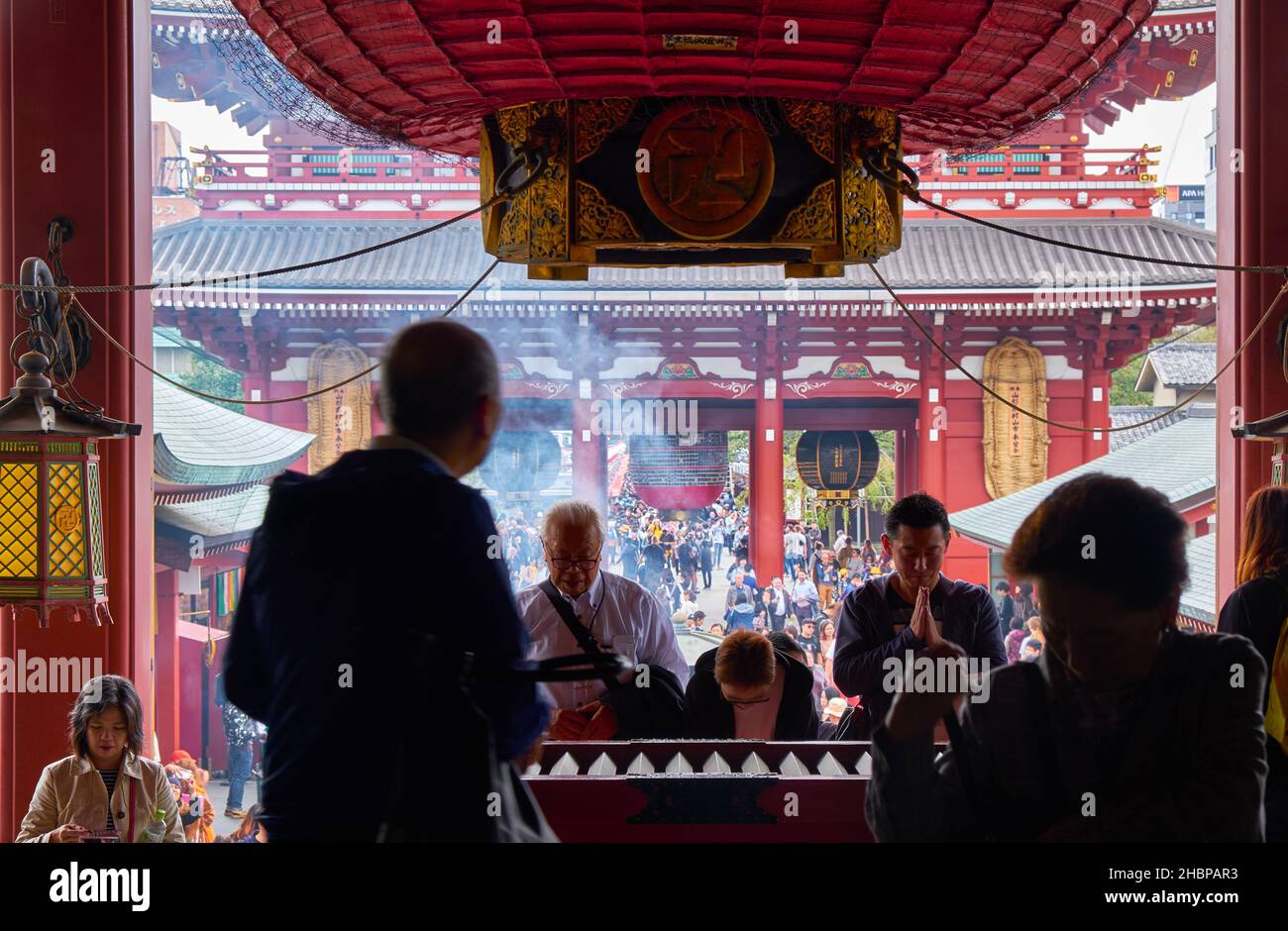 Tokyo, Japan - October 24, 2019: People praying at the entrance to the ...