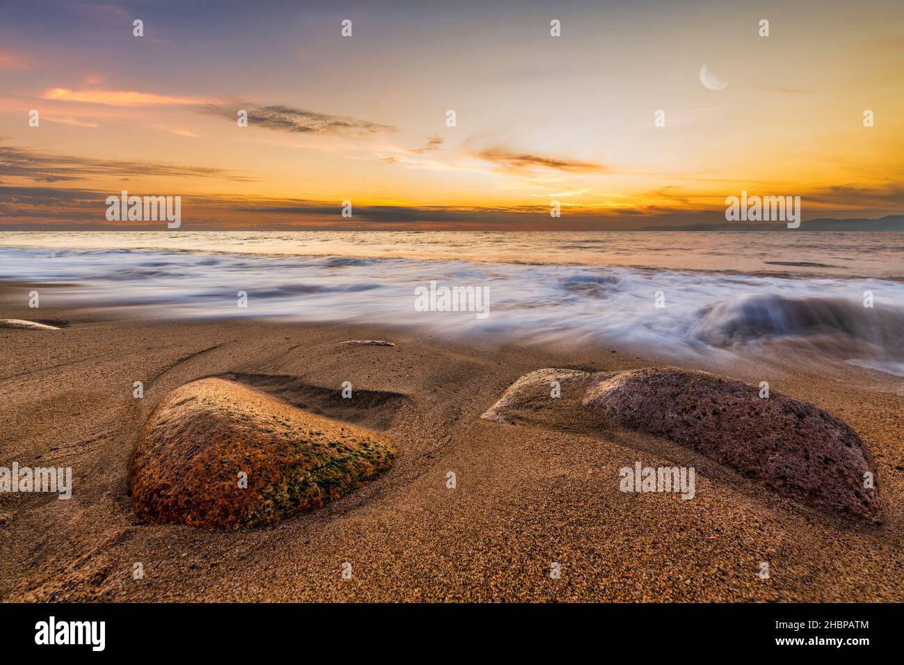 A Beautiful Colorful Ocean Sunset As The Moon Rises In The Sky And A ...