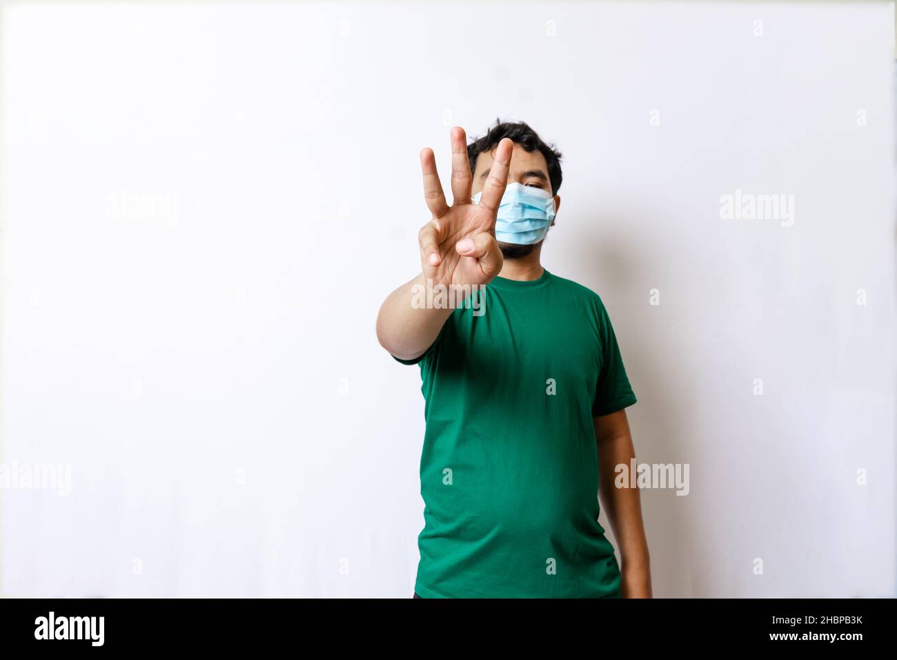 asian man in green shirt with random pose wearing mask Stock Photo - Alamy