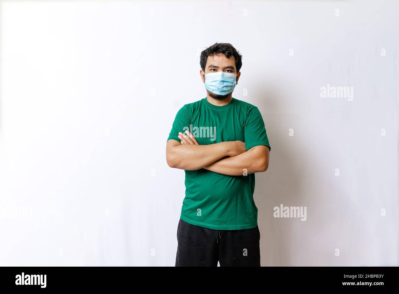 asian man in green shirt with random pose wearing mask Stock Photo - Alamy