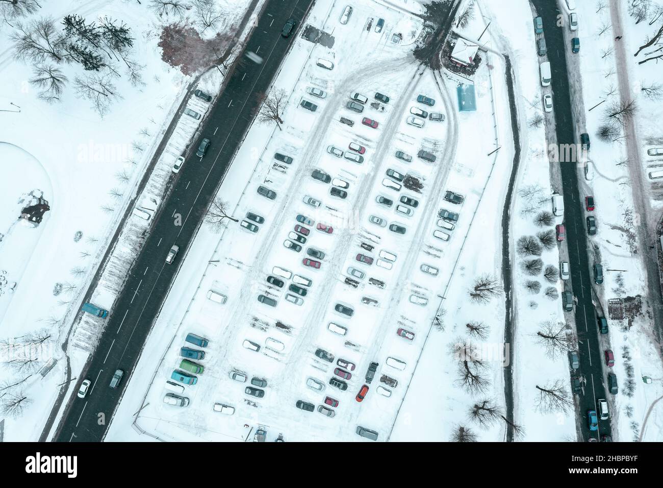 parking lot at winter season with snow-covered cars. aerial photography ...