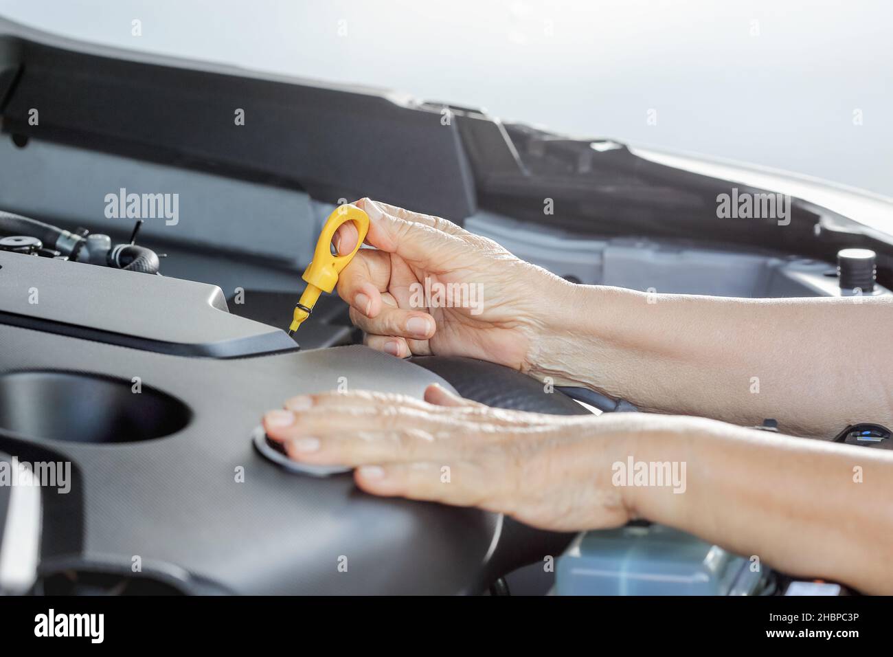 Elderly woman repairing her car Stock Photo - Alamy