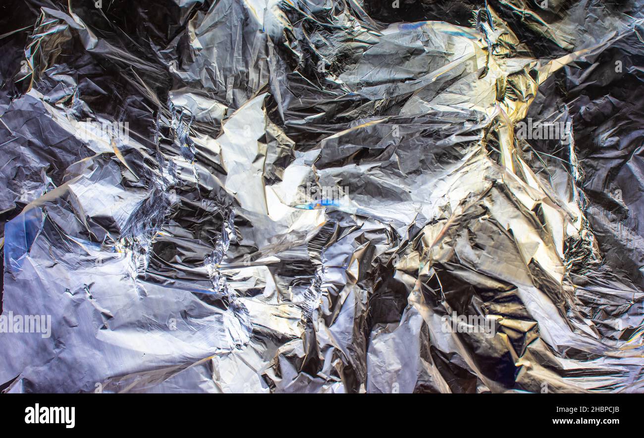 A stretched plastic bag reveals stress patterns under polarised light ...