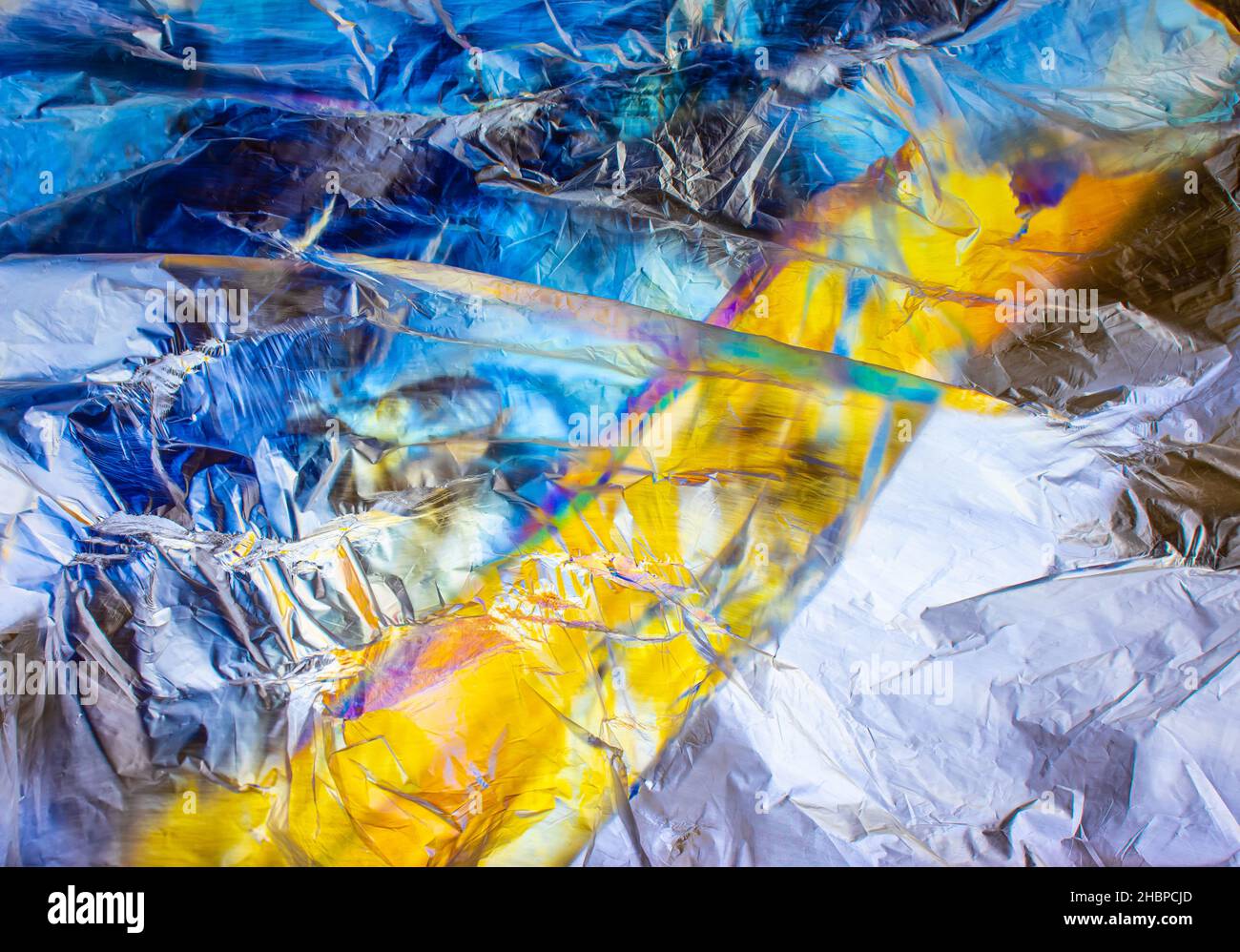 A stretched plastic bag reveals stress patterns under polarised light ...