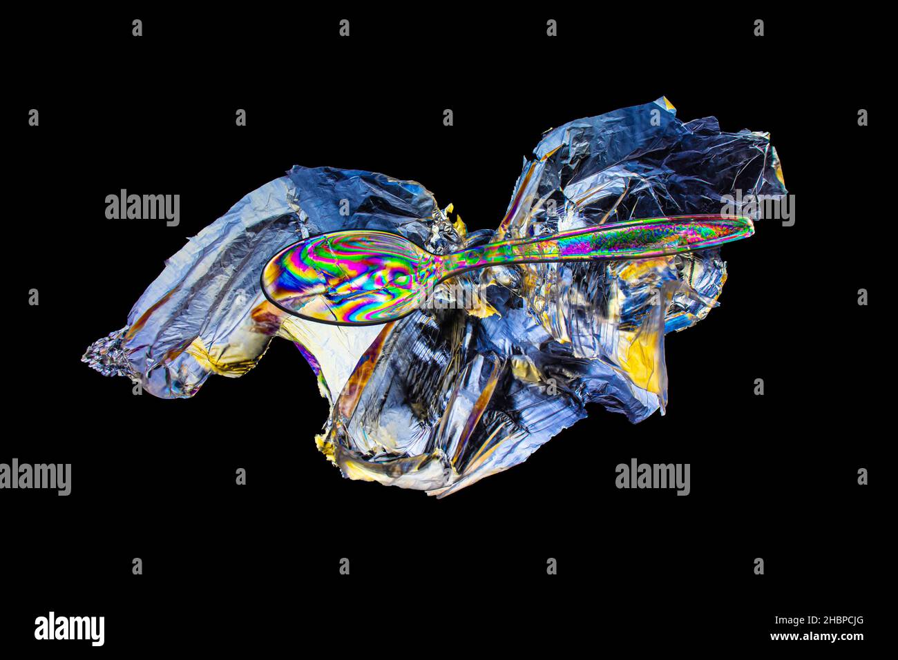 Stress patterns in a plastic spoon are revealed under polarised light ...
