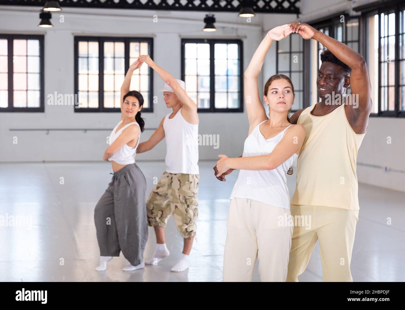 Four dancers exercising bachata movements Stock Photo - Alamy