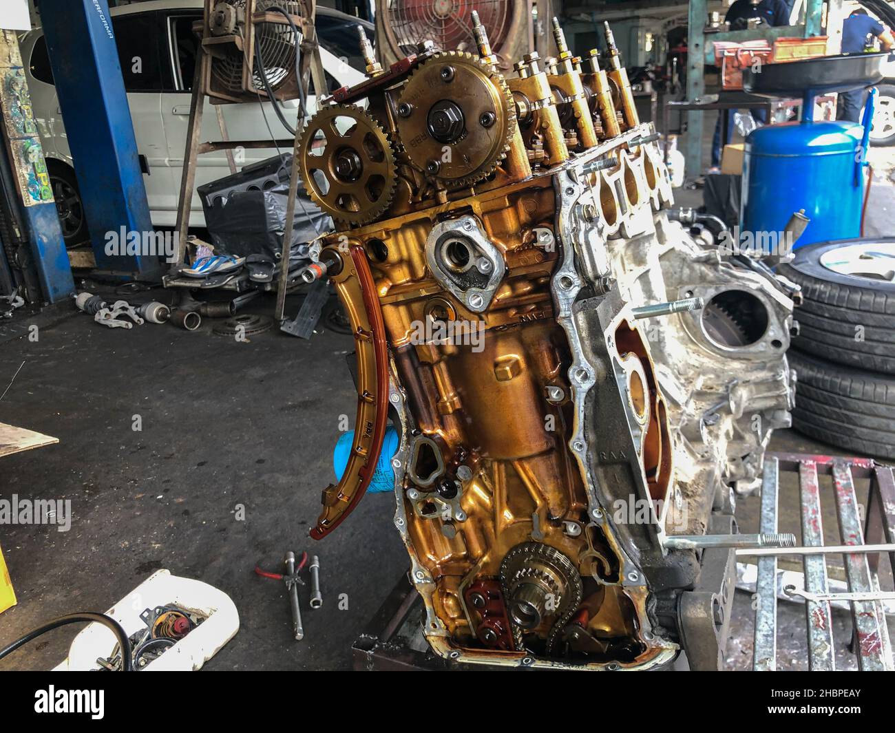 Mechanic man dismantles the opposing car engine for repair at the stand ...