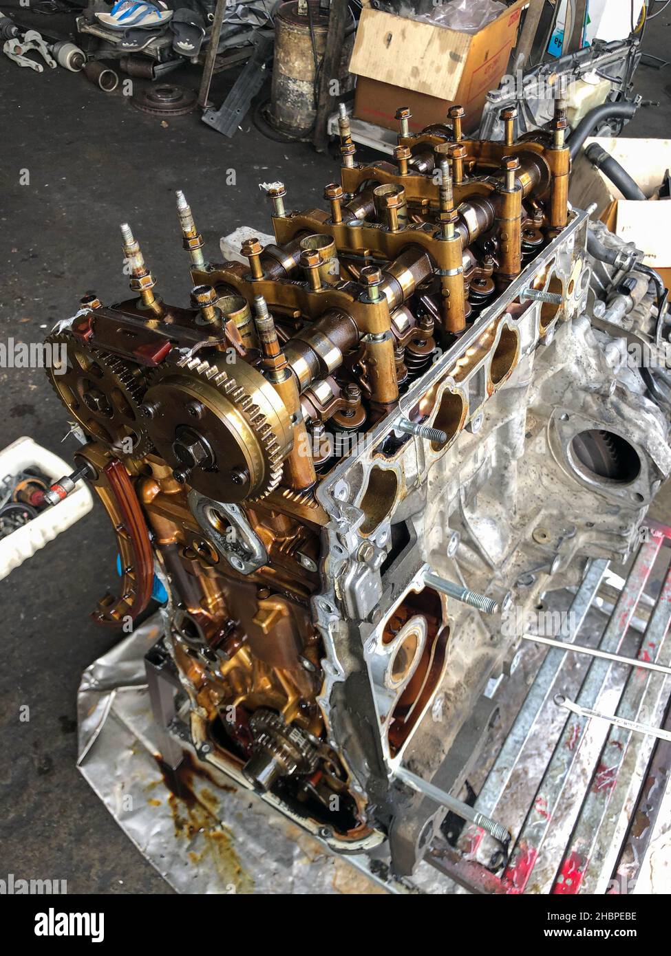 Mechanic man dismantles the opposing car engine for repair at the stand ...