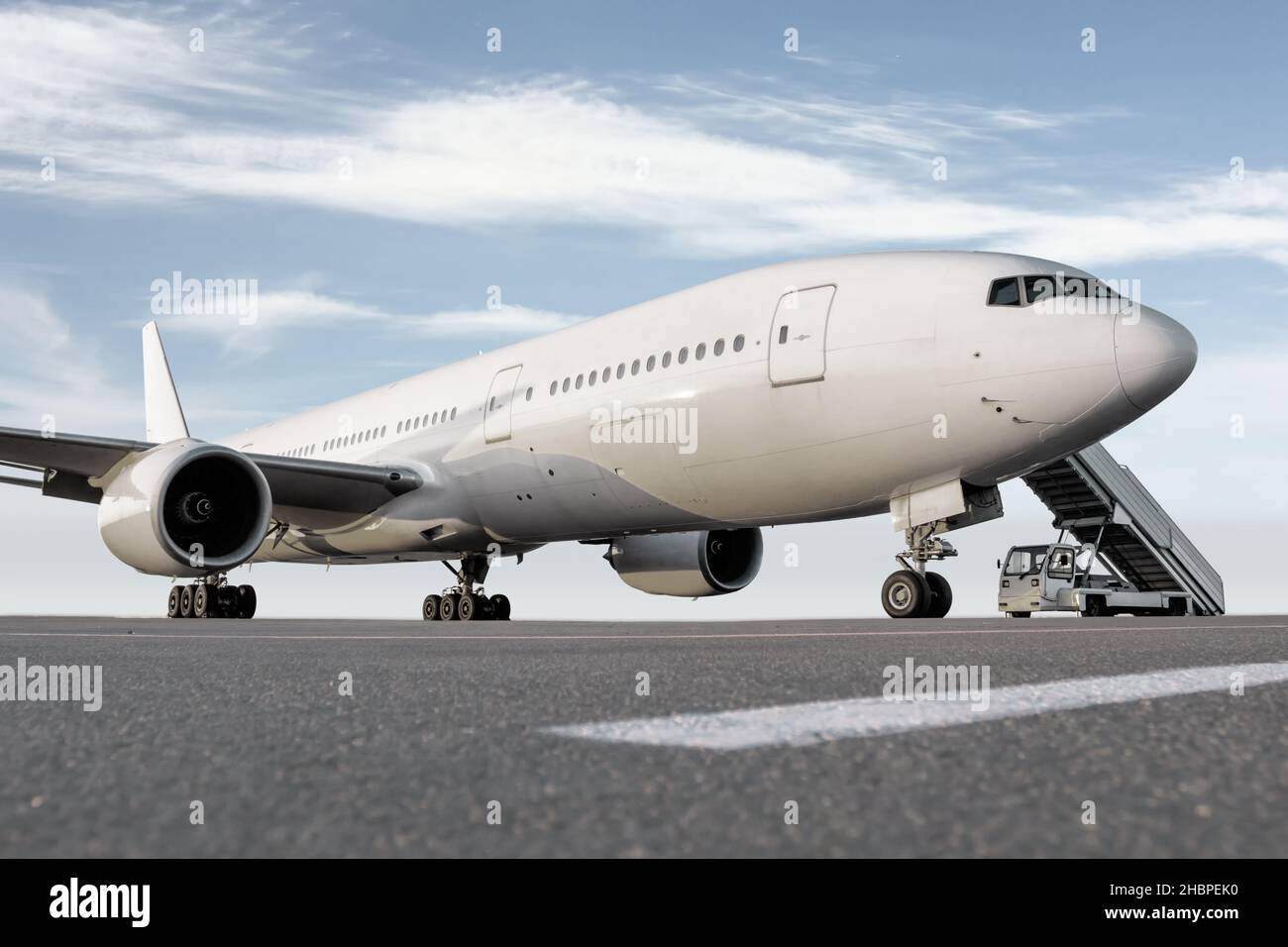 Wide body passenger airliner with a boarding stairs at the airport ...