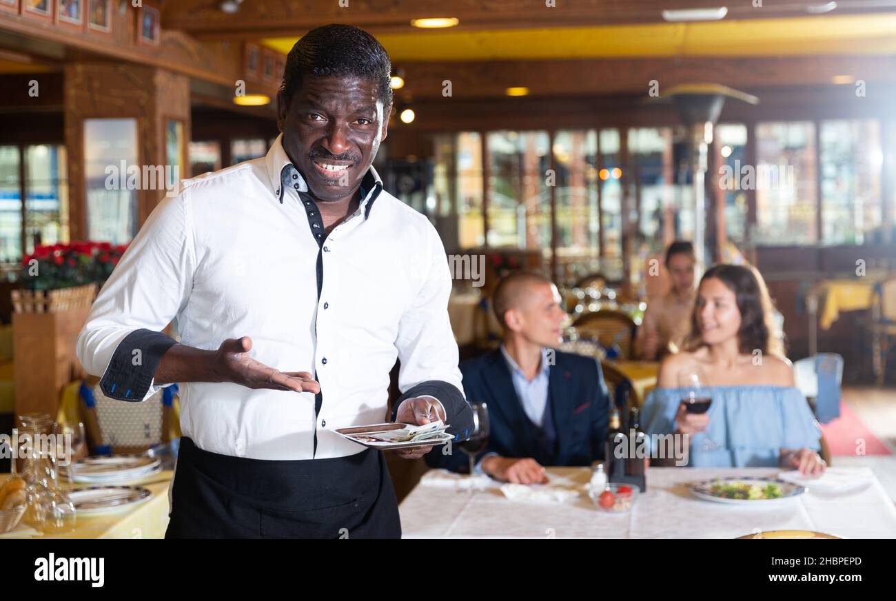 Male waiter demonstrating his upset with little tips from restaurant ...