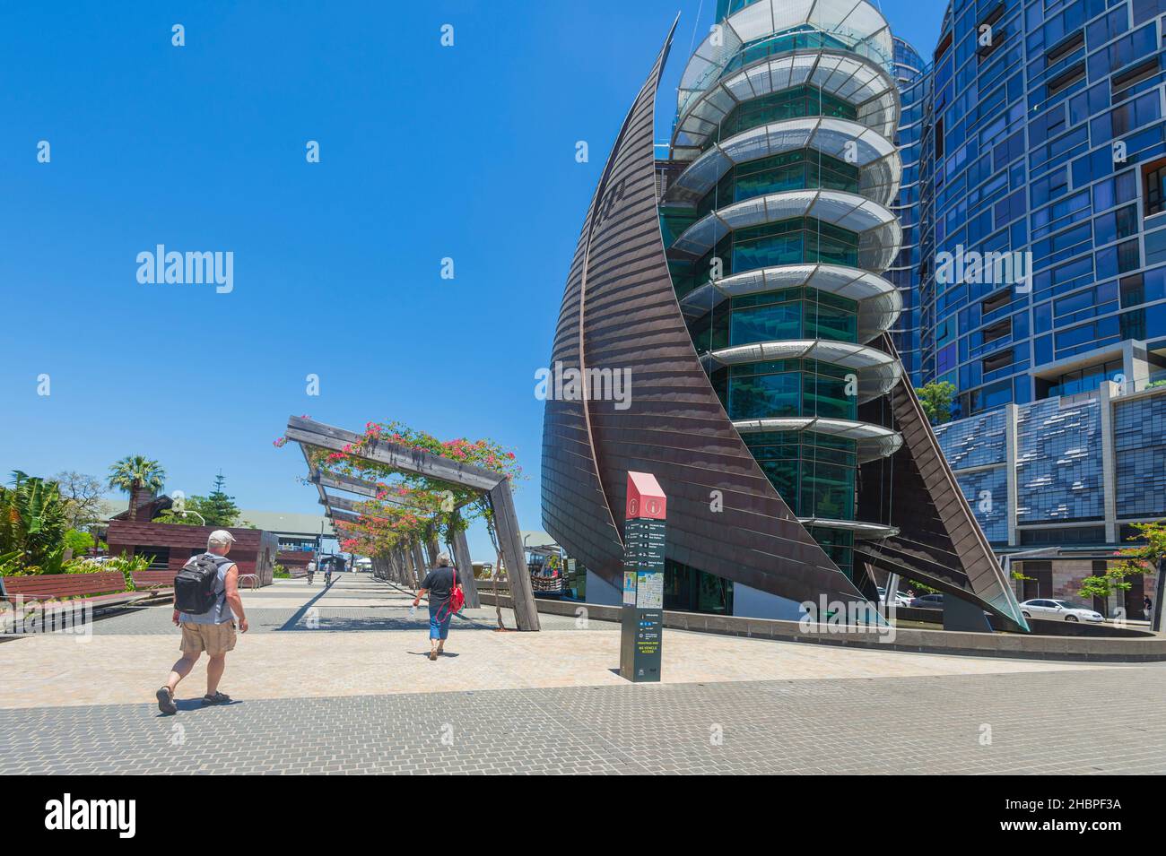 Tourists walking past the modern building of the Bell tower, a popular ...