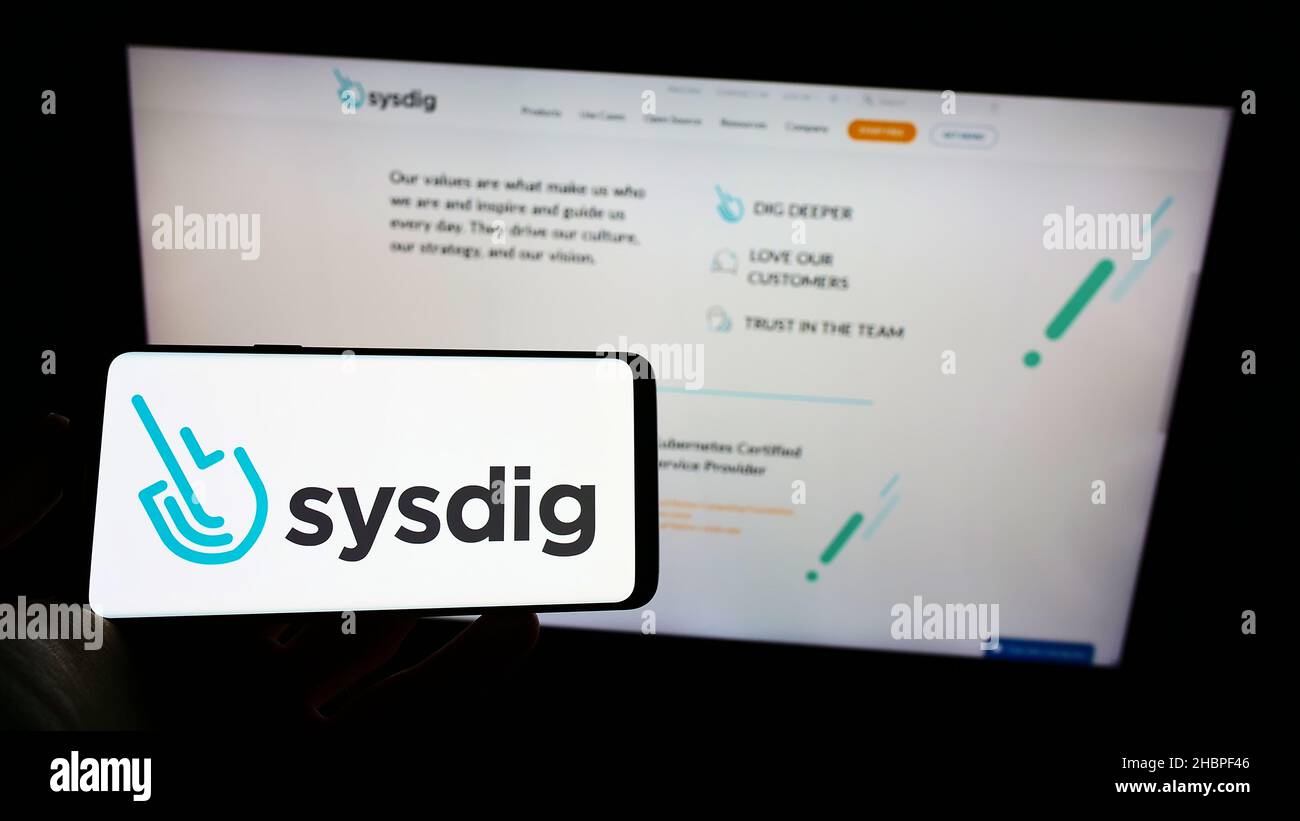 Person holding mobile phone with logo of American cloud security ...