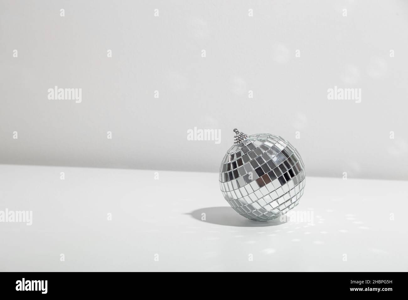 Gray disco ball lies on silver background with shadow. Copyspace Stock ...