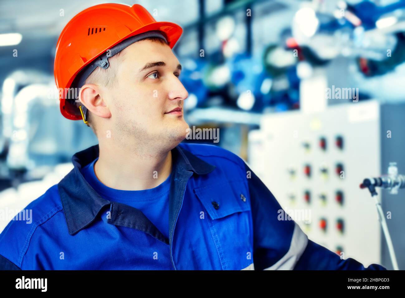 Operator of gas boiler house checks pressure on equipment. Portrait of ...