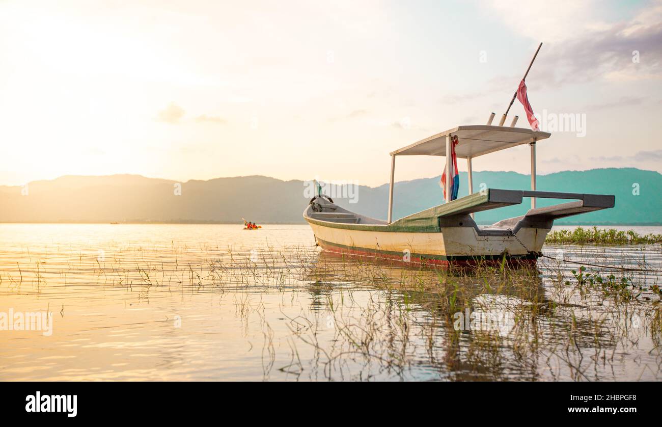 Beautiful sunset view of Timah Tasoh lake with boat by the lakeside ...