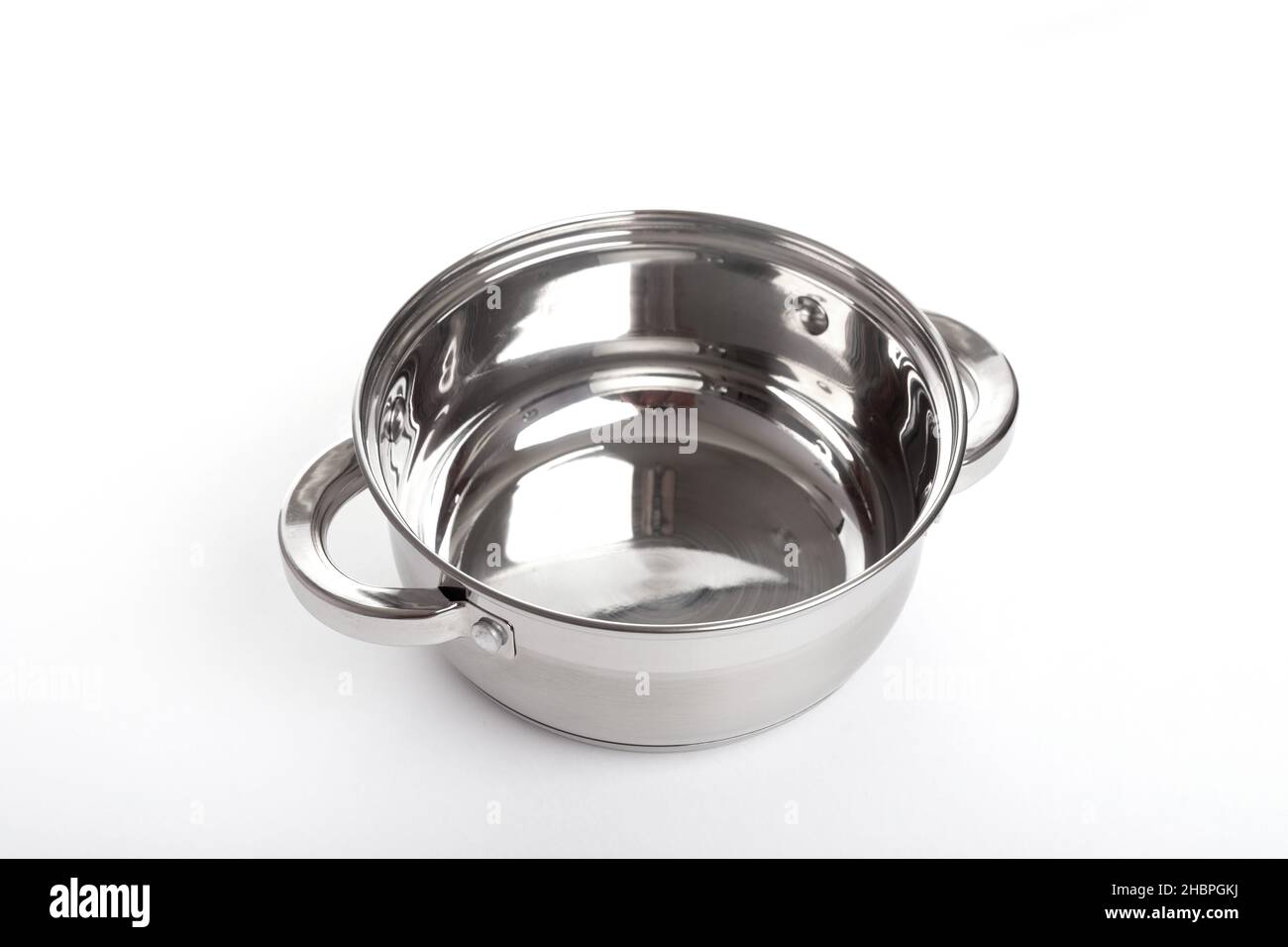empty stainless steel pans on white background, top view Stock Photo ...