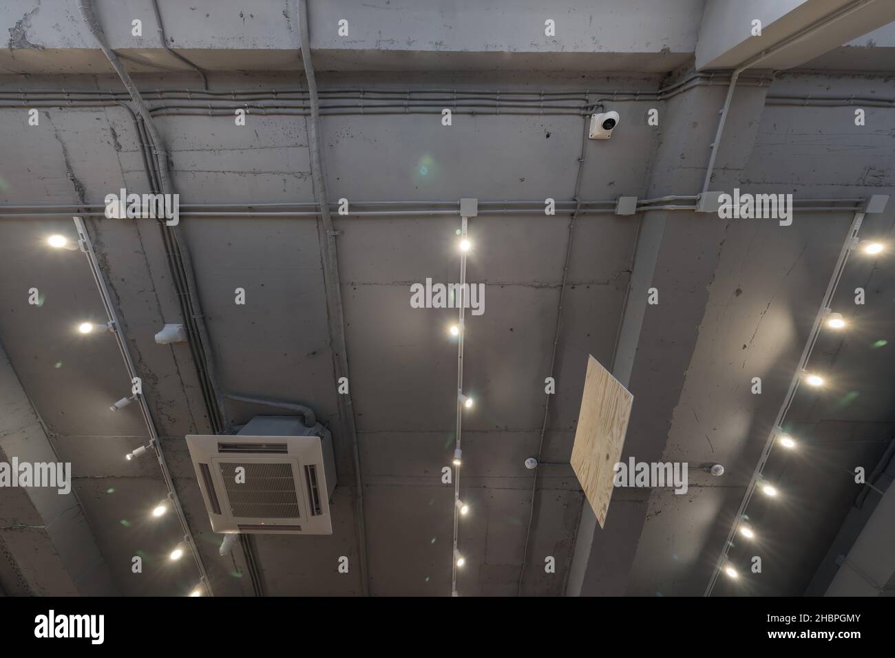 Abstract loft interior of concrete grey ceiling with air ventilation ...
