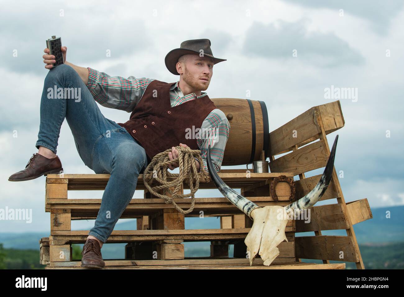 Cowboy farmer man in country side wearing western cowboy hat. Guy ...