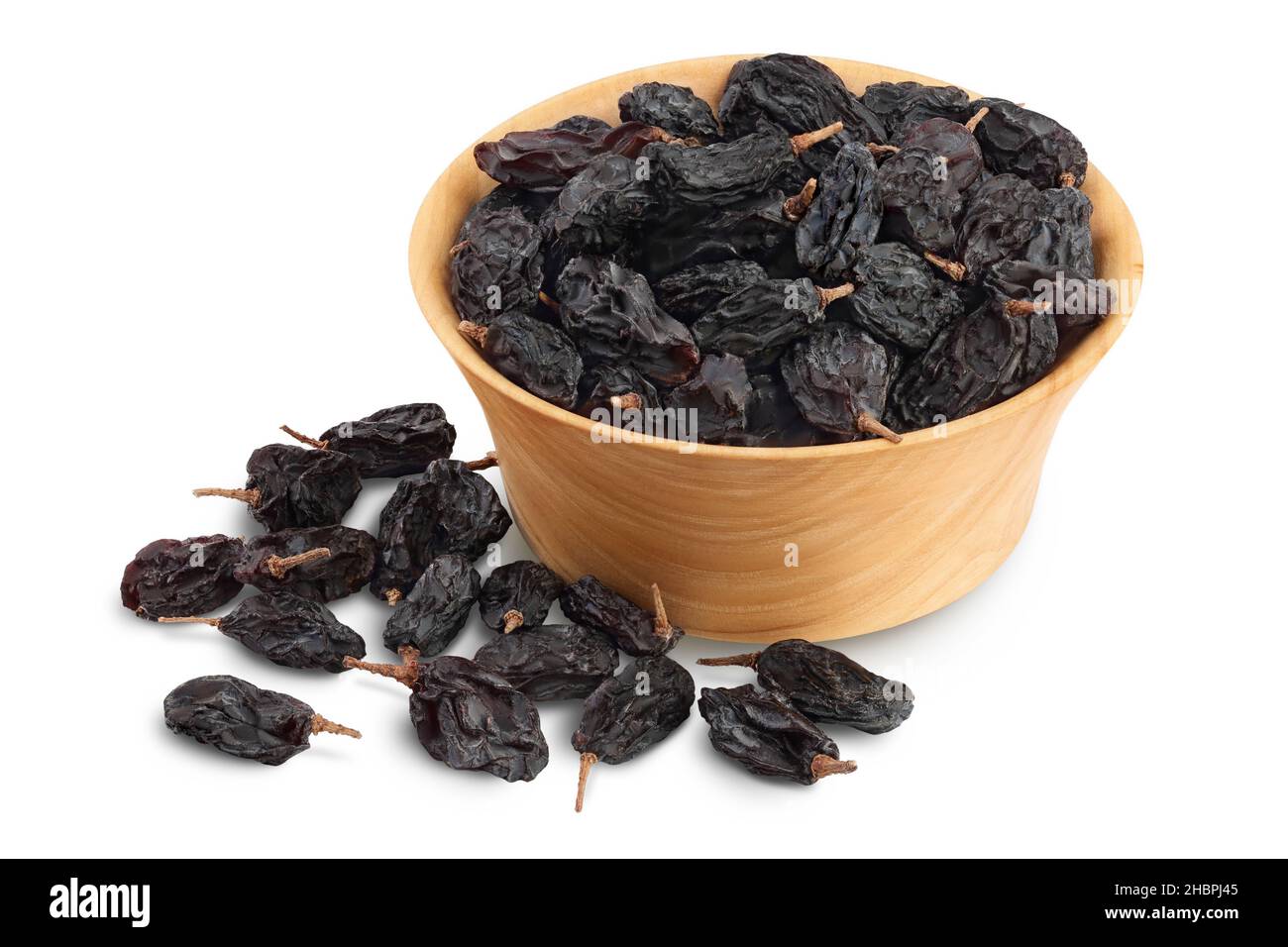 Yellow raisins in wooden bowl isolated on white background with ...