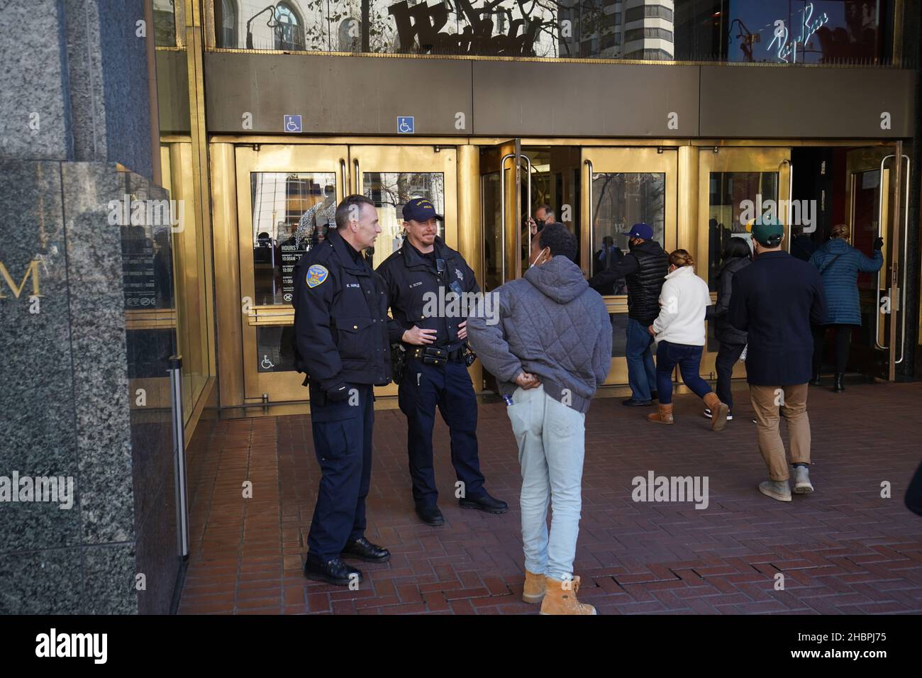 Policemen standing outside Macy’s shopping mall are seen questioning a ...