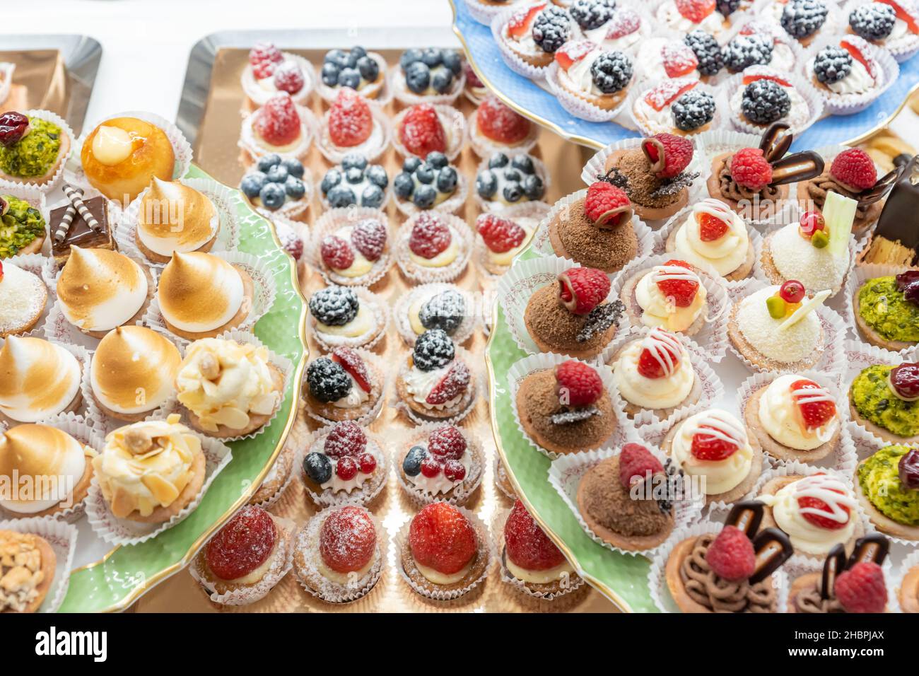 Pastry shop display window with variety of mini desserts and cakes ...