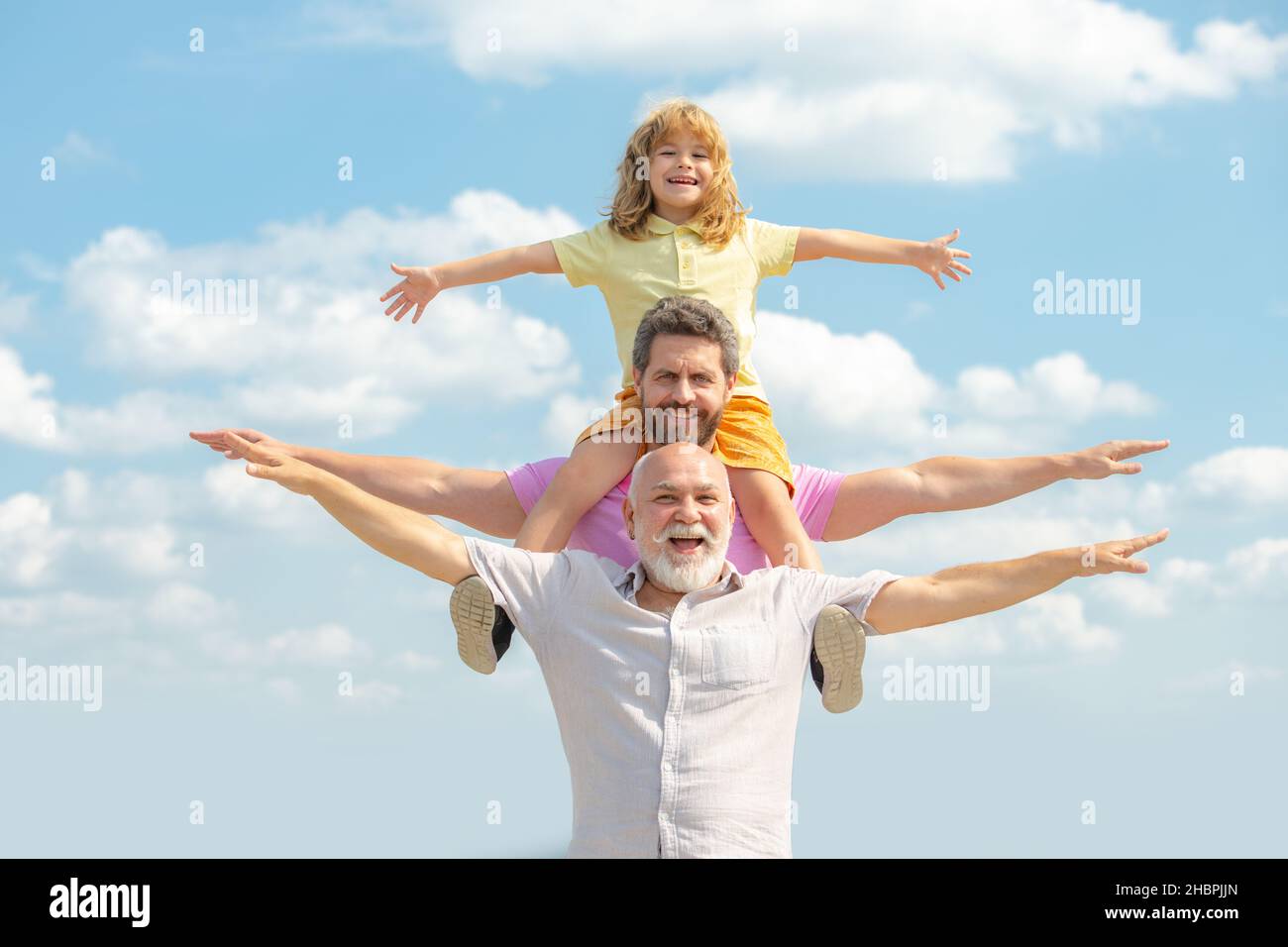 Fathers day. Father and son with grandfather raising hands or open arms ...